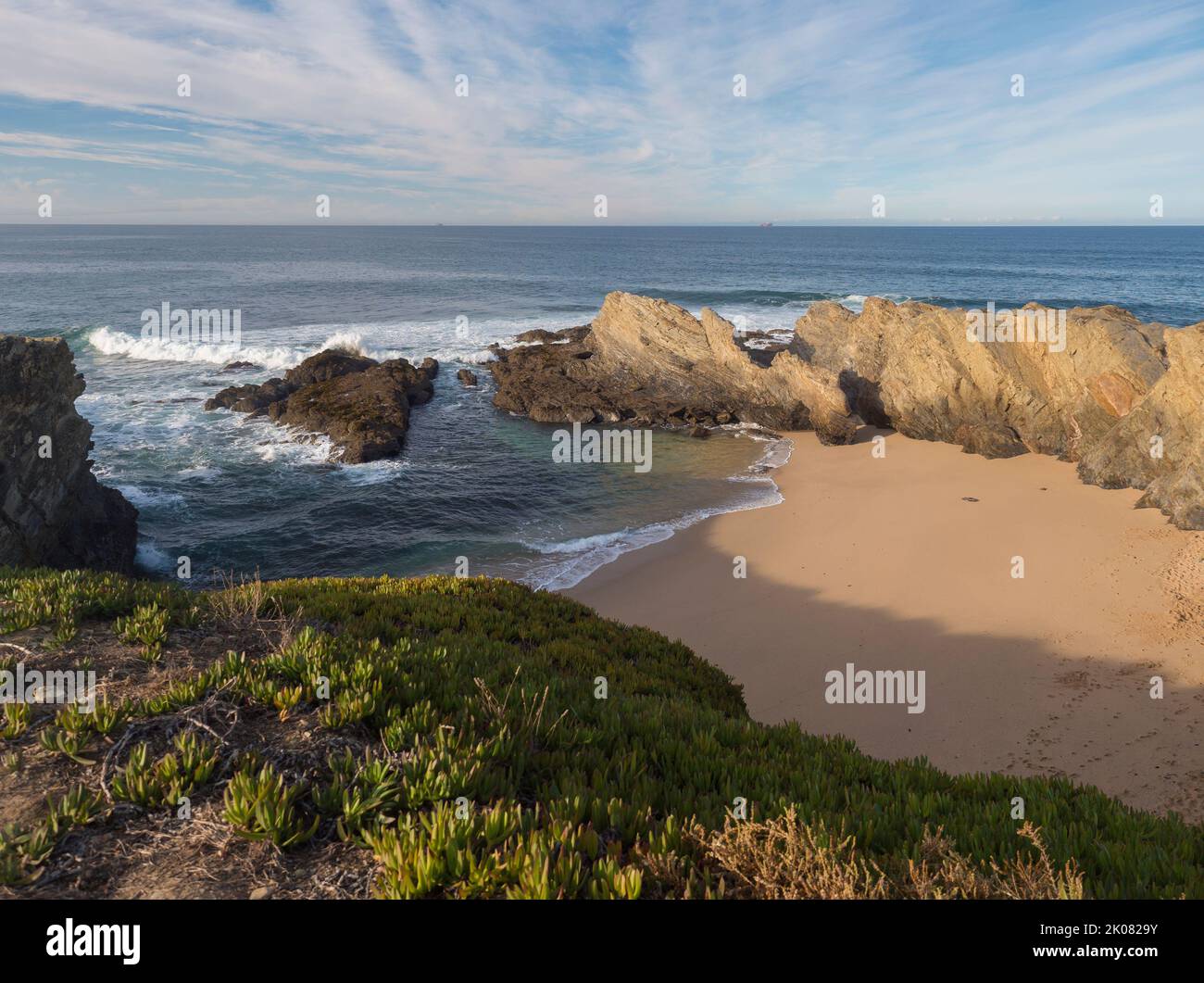 View of empty Praia dos Buizinhos sand beach with ocean waves and sharp ...