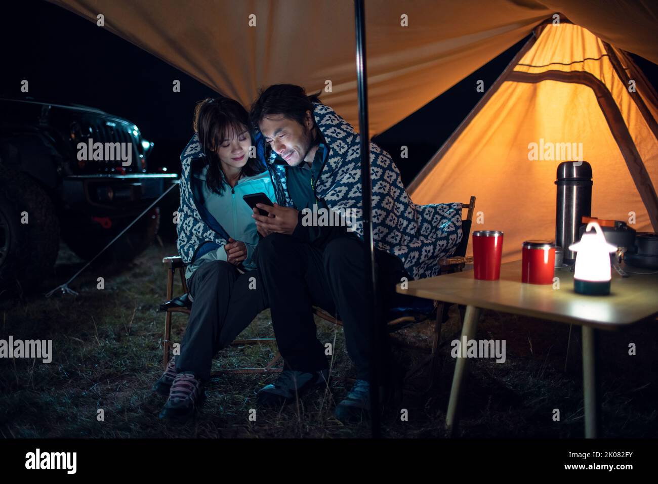 Happy Chinese couple camping outdoors Stock Photo - Alamy