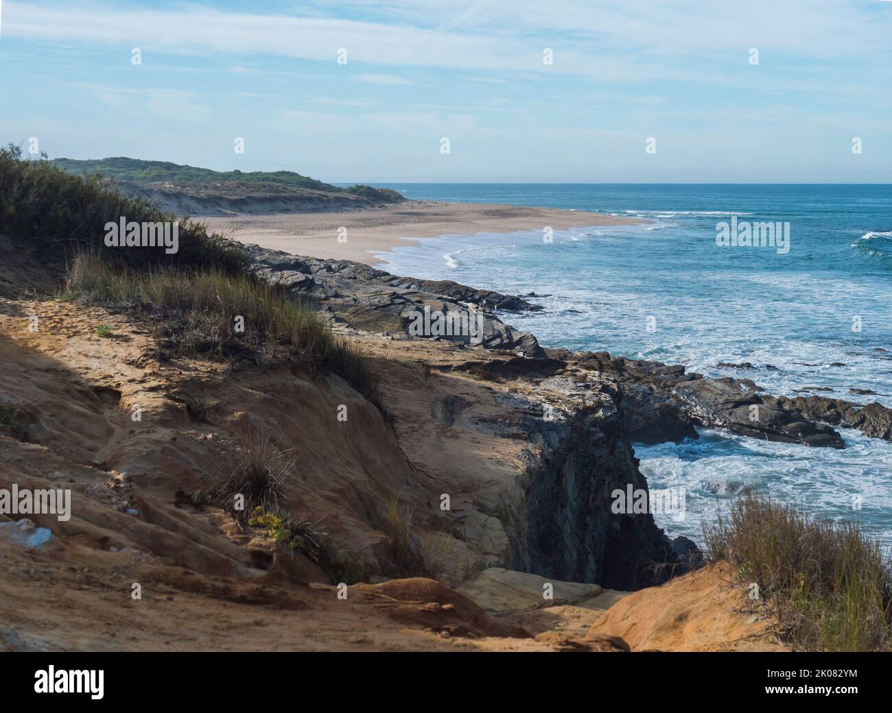 View of empty Praia do Sissal sand beach with ocean waves and sharp ...