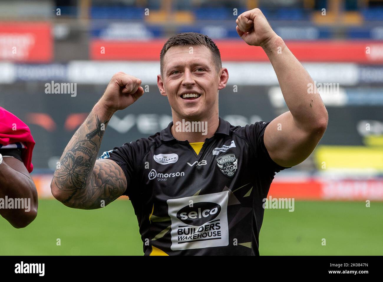 Deon Cross #28 of Salford Red Devils celebrates the victory over ...