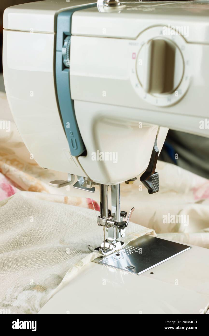 Modern sewing machine presser foot and colofrul cloth. Sewing process ...
