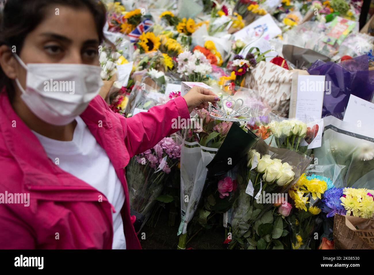 People place flowers at Buckingham Palace, following the passing of ...