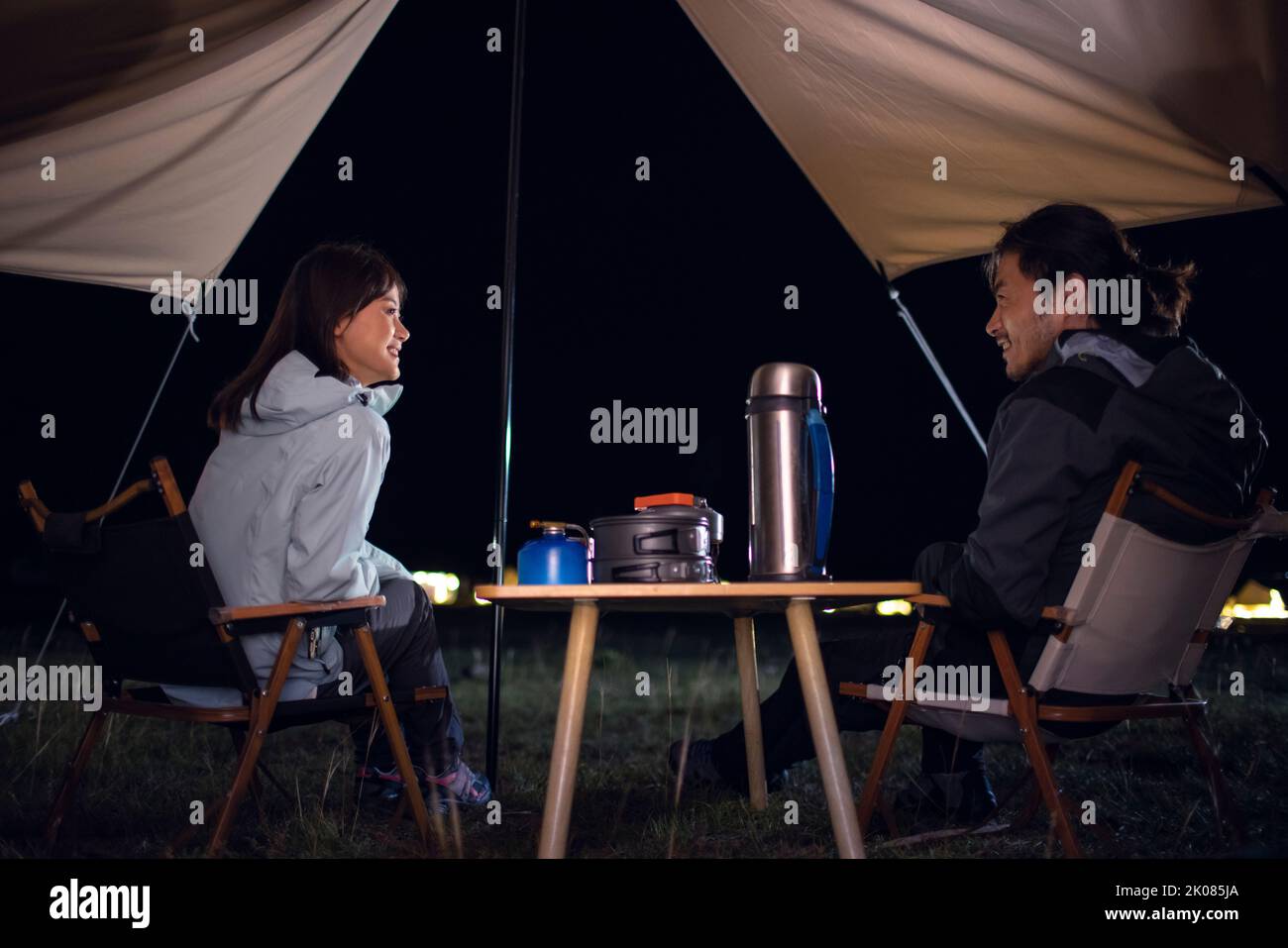 Happy Chinese couple camping outdoors Stock Photo - Alamy