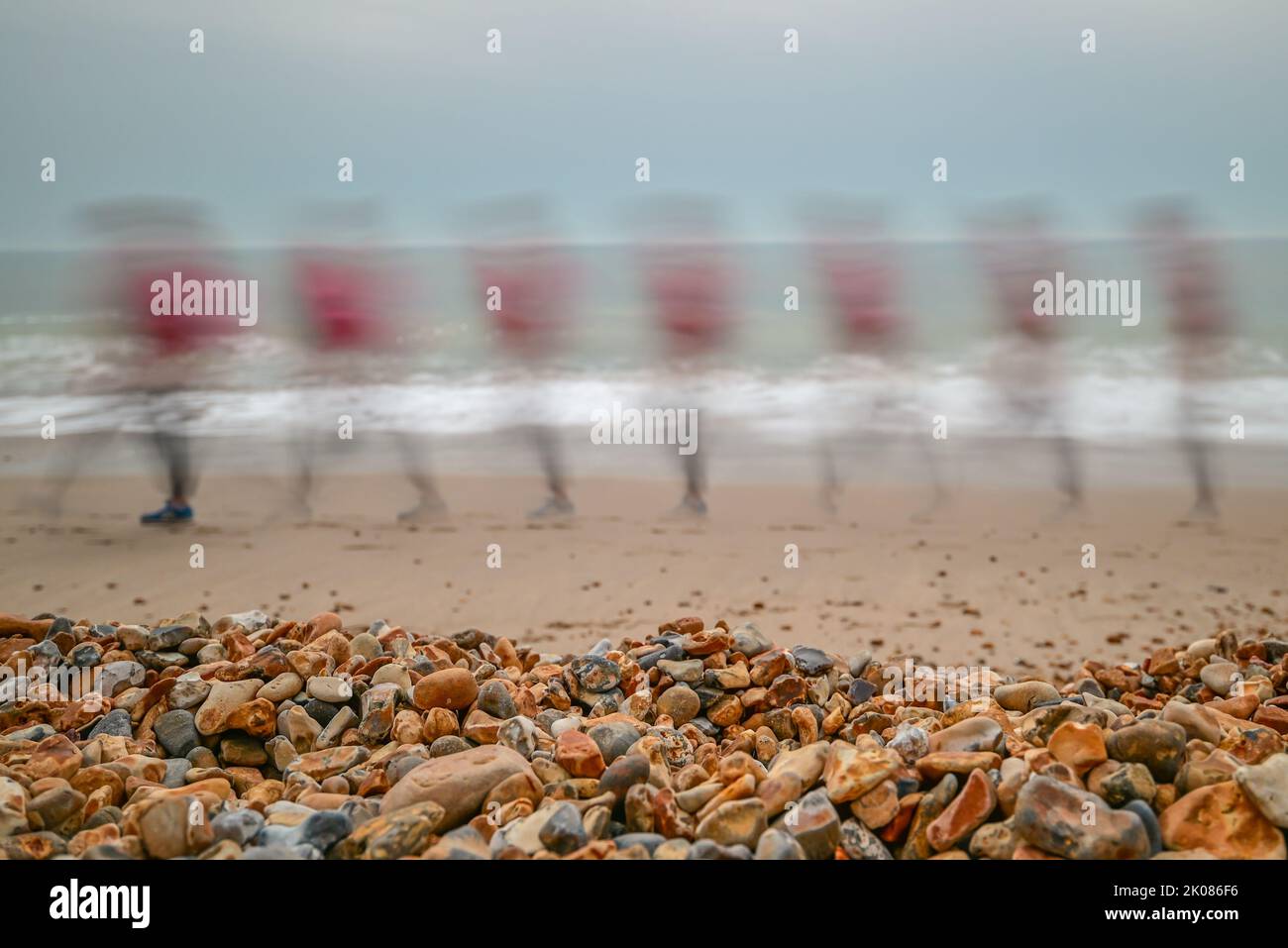 Figure walking on a beach with pebbles, multiple exposure Stock Photo ...
