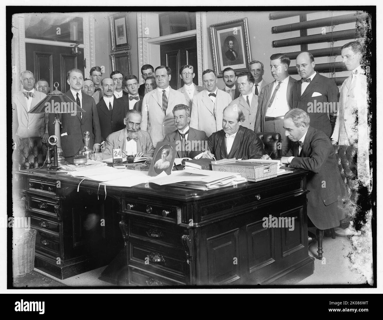 Group: includes William Jennings Bryan (at desk, 2nd from right); and ...