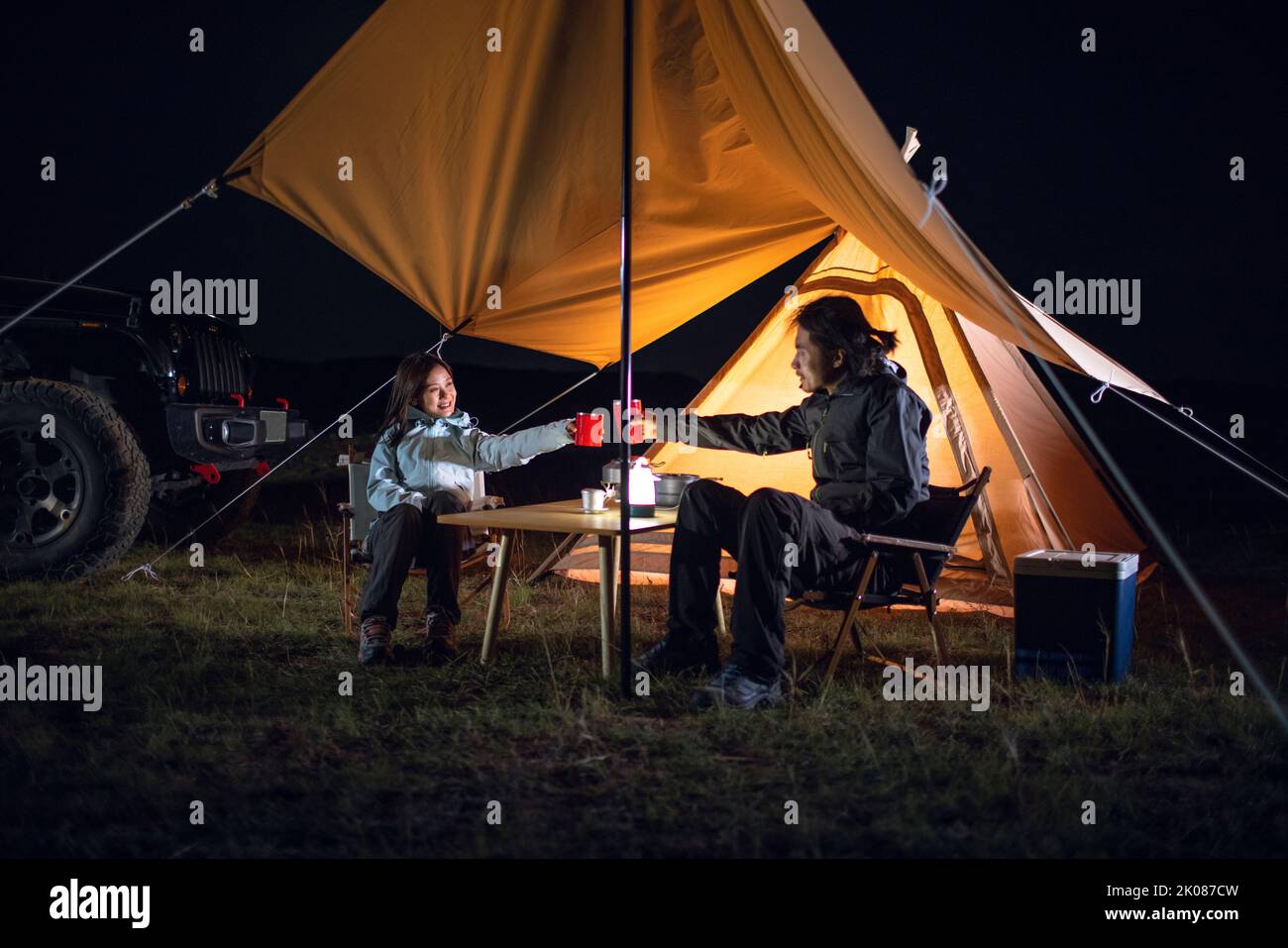 Happy Chinese couple camping outdoors Stock Photo - Alamy