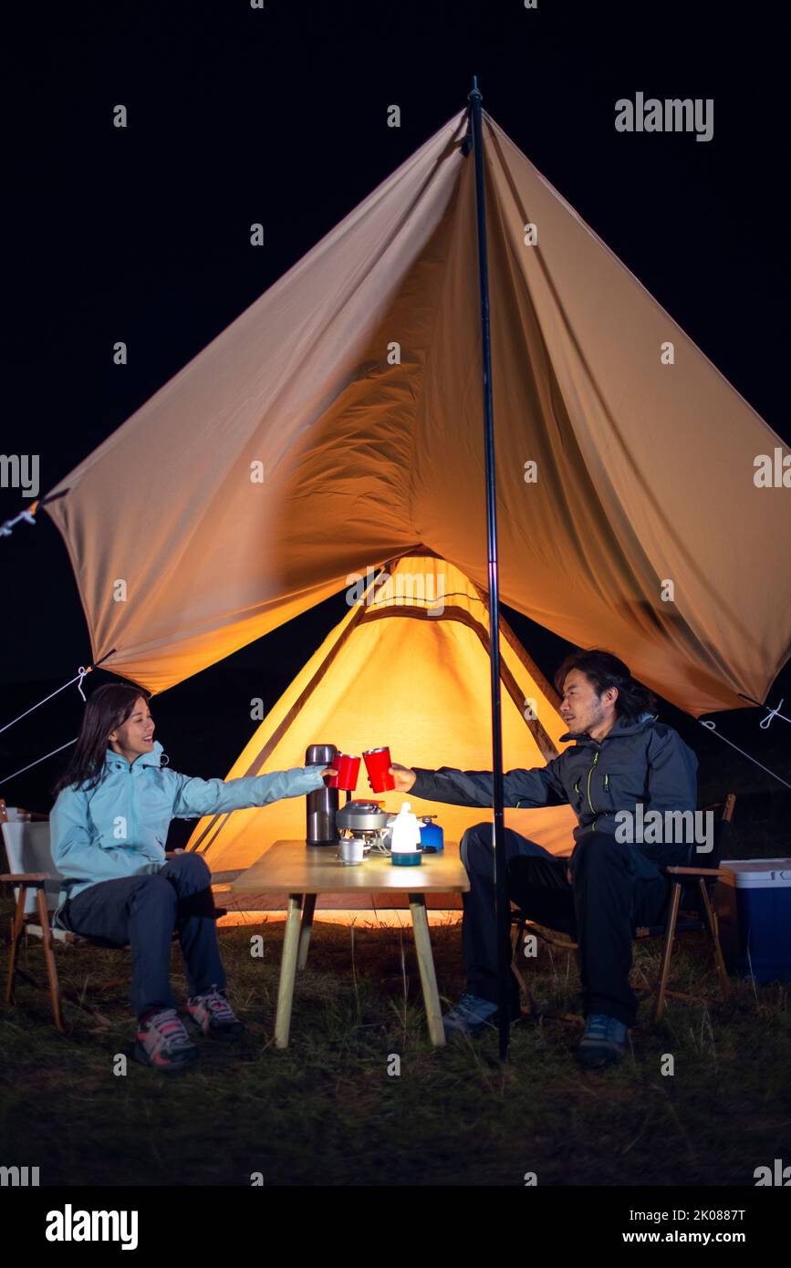 Happy Chinese couple camping outdoors Stock Photo - Alamy