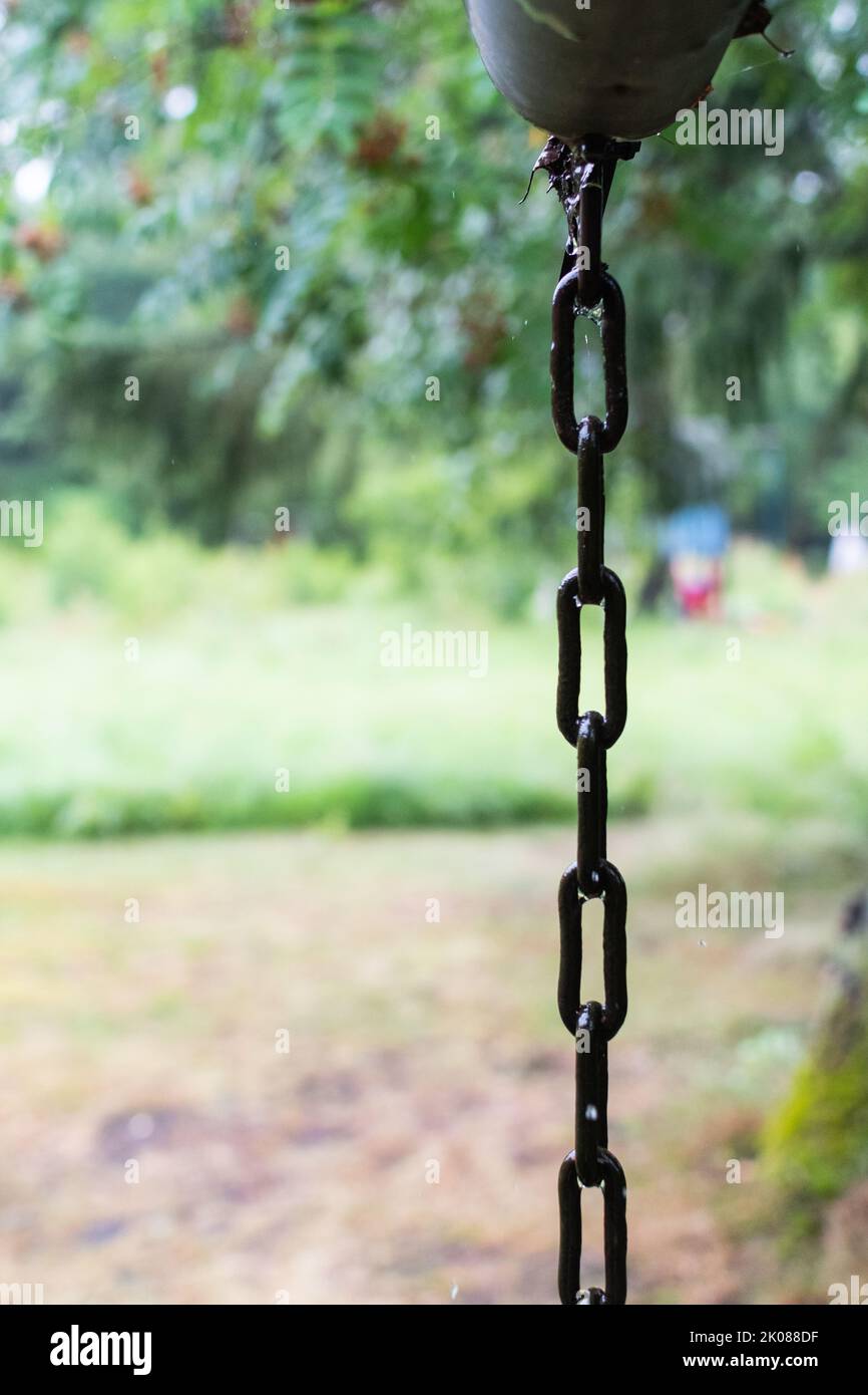 water trickling down a chain hanging from a gutter Stock Photo - Alamy