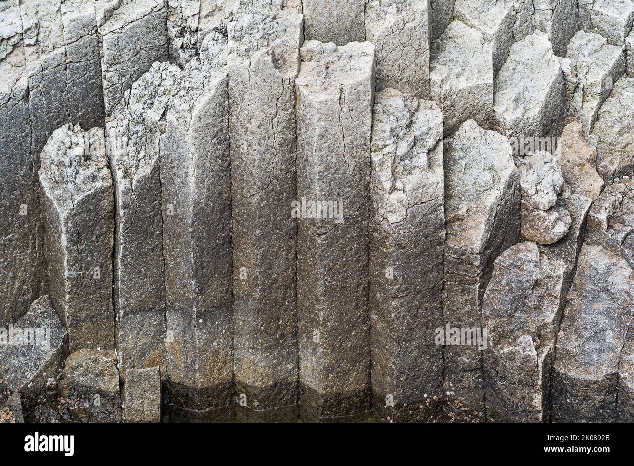 natural background, the surface of a volcanic coastal rock from basalt ...