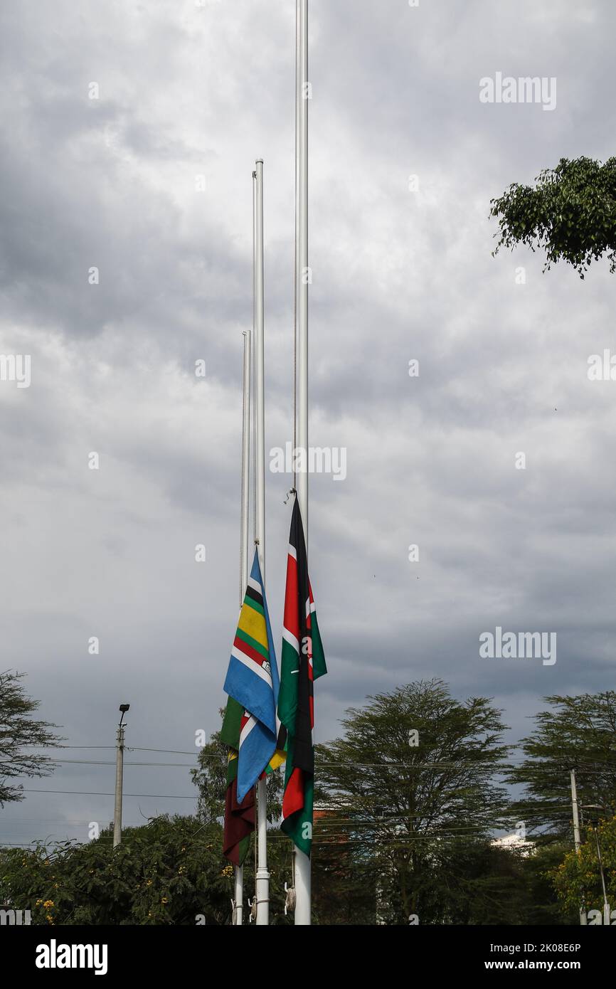 The flag of Kenya (R), East African Community flag (C) and that of the ...