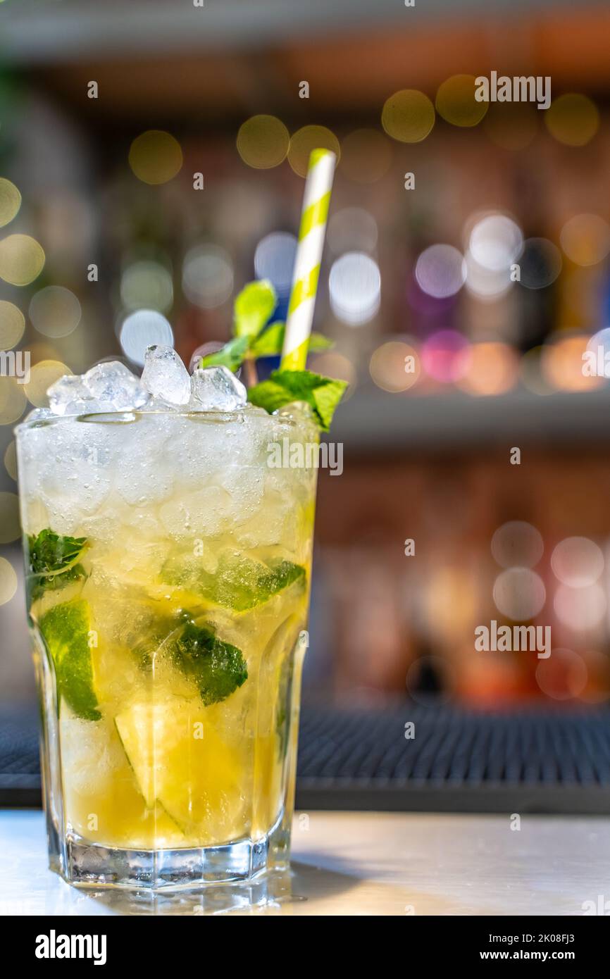 Mojito cocktail on bar counter with lemons, limes and species with copy ...