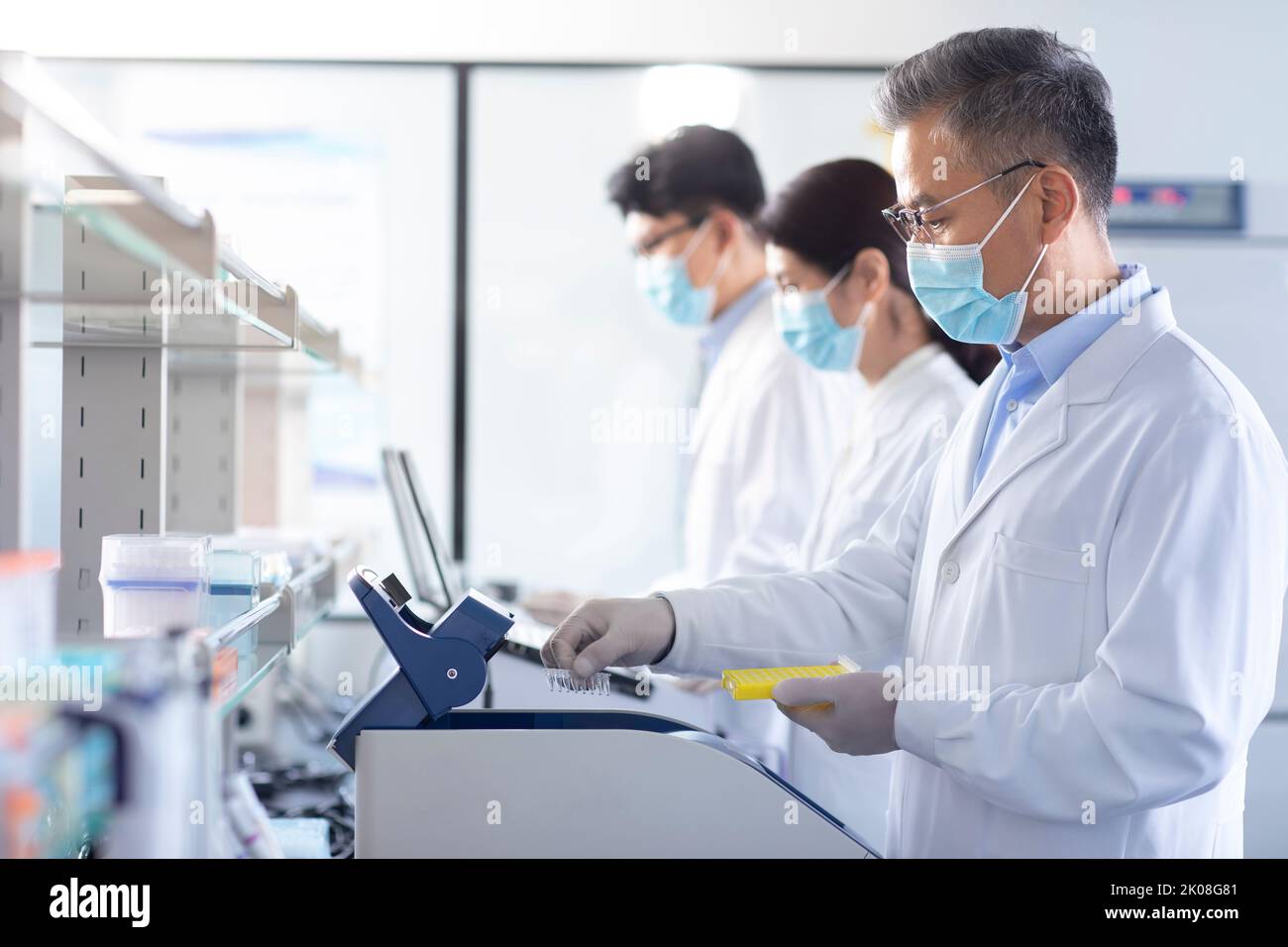 Chinese scientist examining medical samples in laboratory Stock Photo ...
