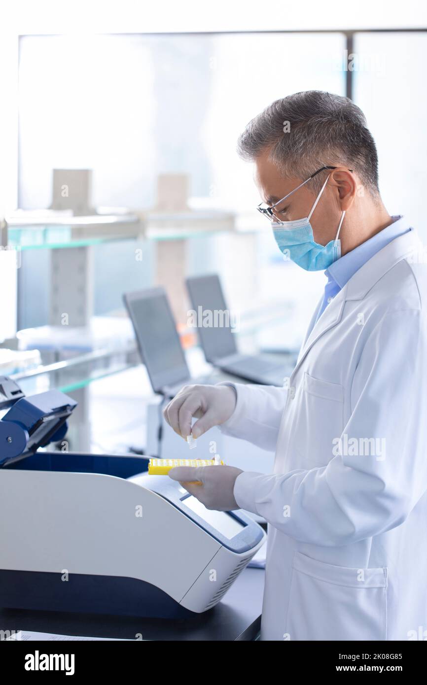 Chinese scientist examining medical samples in laboratory Stock Photo ...
