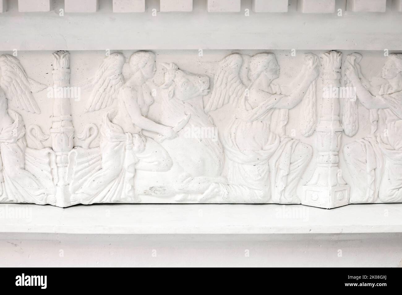 White bas-relief on frieze with angels and sacred cows closeup. Classic ...