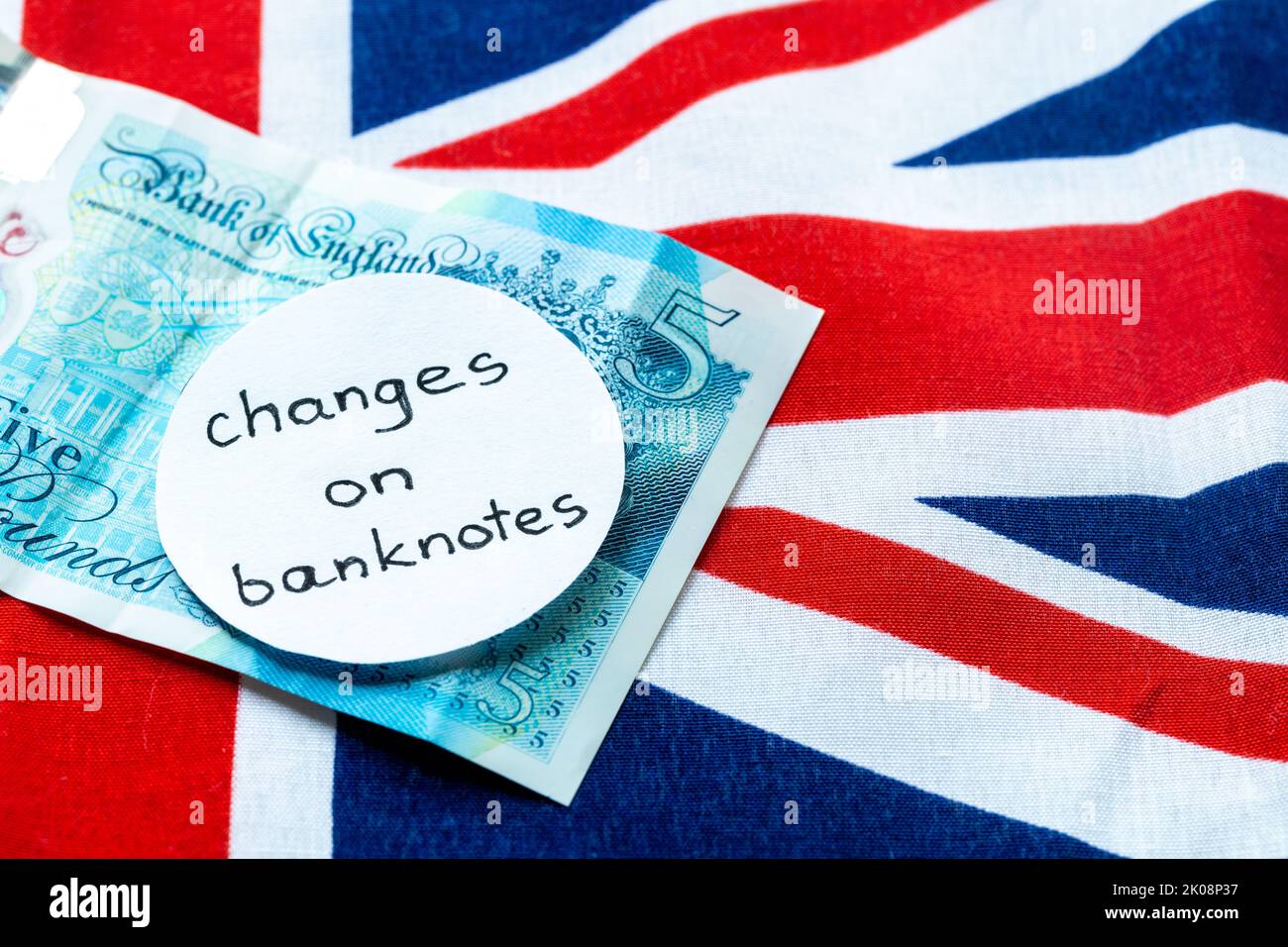 English £ 5 banknote with blurred image of the queen and handwritten ...