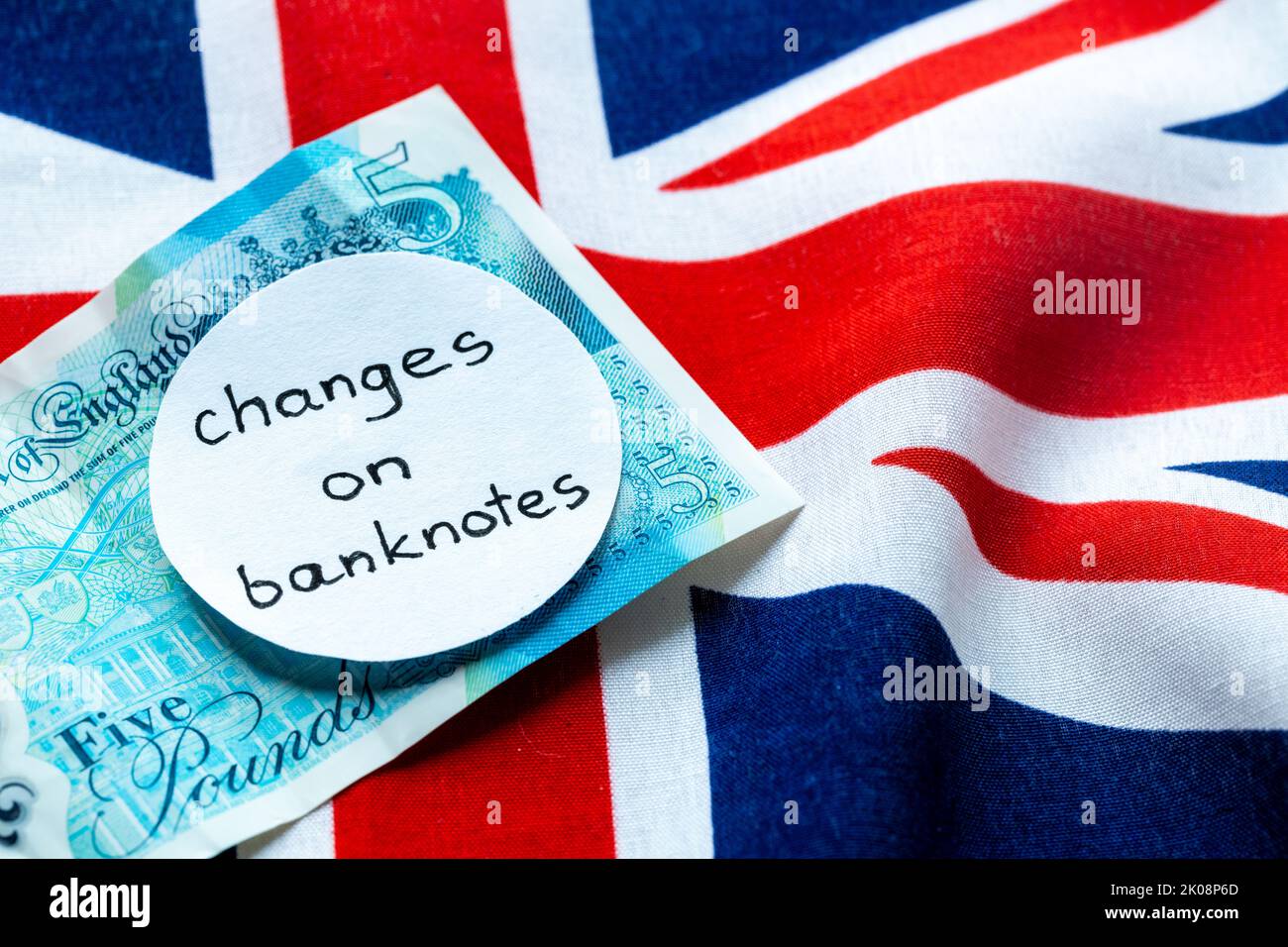 English £ 5 banknote with blurred image of the queen and handwritten ...