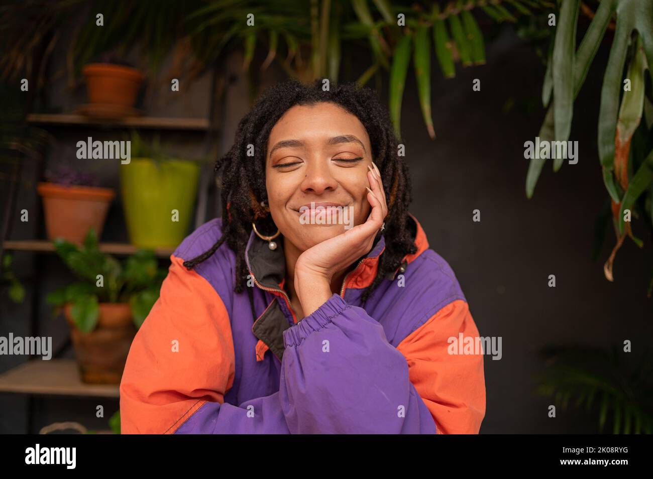 Happy woman with eyes shut seen sitting Stock Photo - Alamy