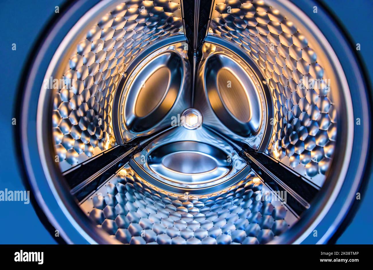 Washing machine drum interior. Perspective inside view into blue ...