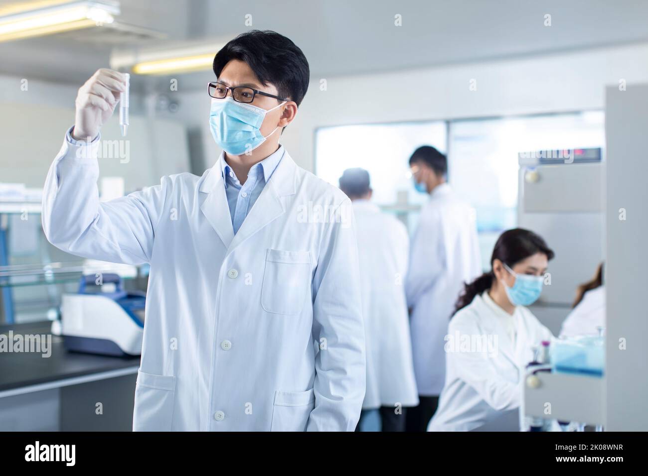 Chinese scientists examining medical sample in laboratory Stock Photo ...