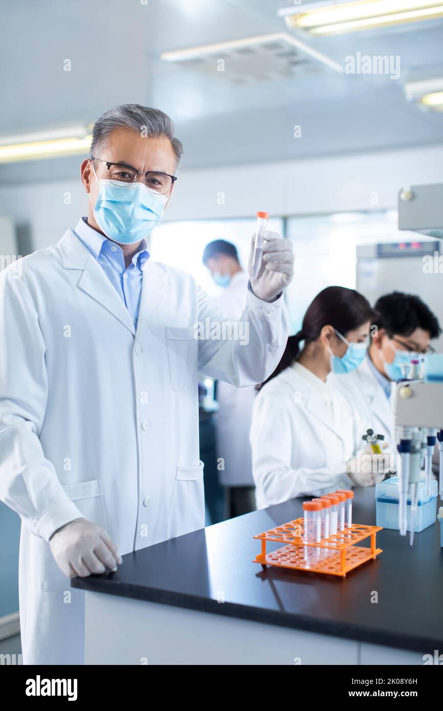 Standing science technology examining expertise laboratory hi-res stock ...