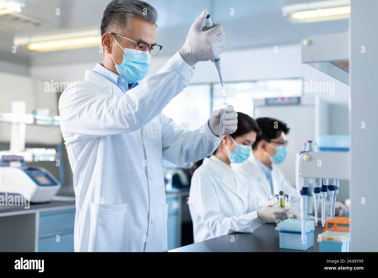 Chinese scientists examining medical sample in laboratory Stock Photo ...