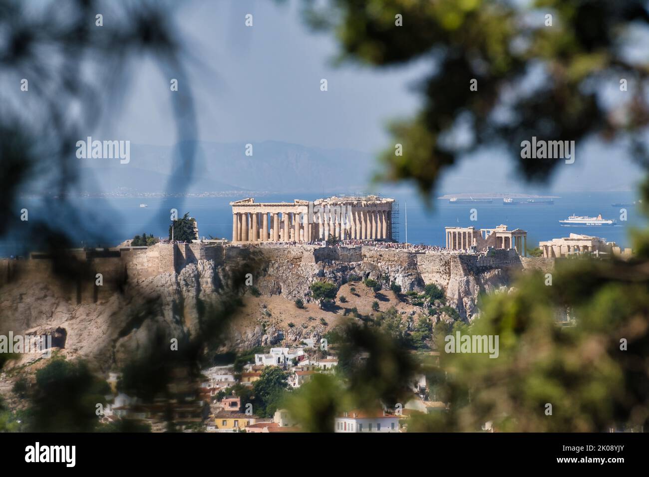 View of the Acropolis through the foliage from the Lycabettus mount in ...