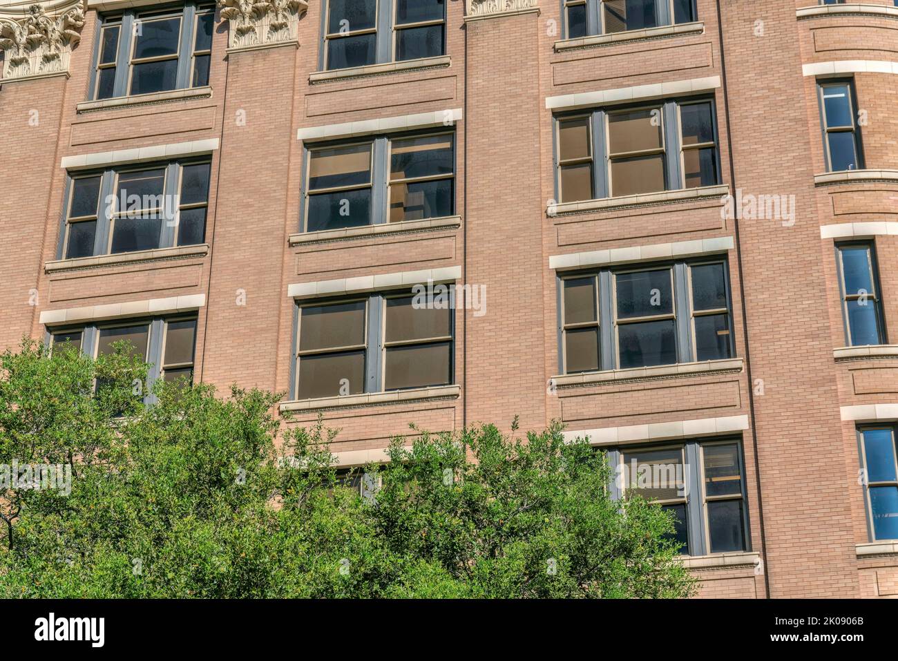Exterior view of modern apartments with brick wall and sliding sash ...