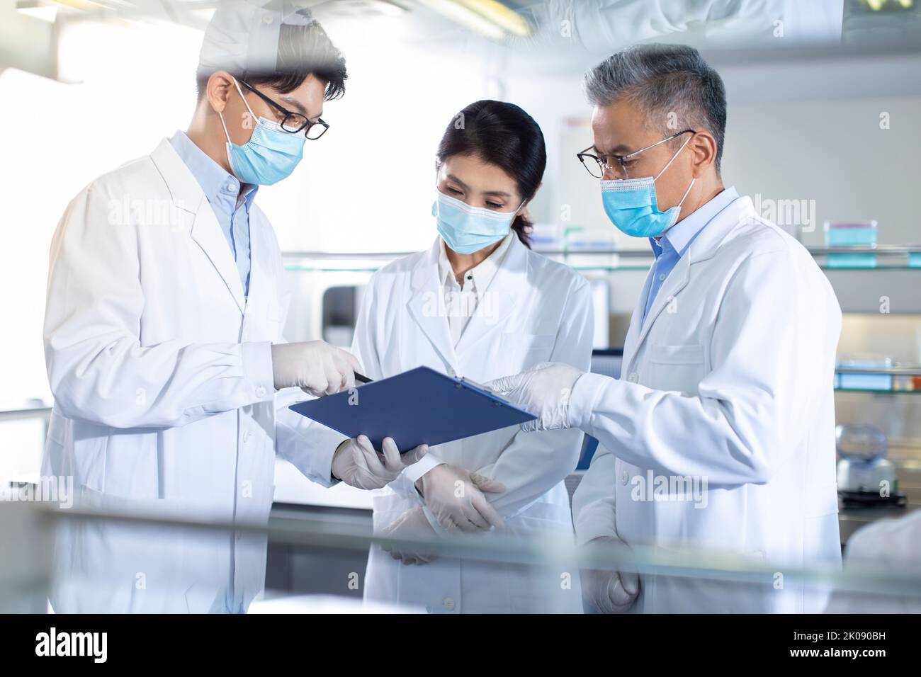Three Chinese researchers discussing in laboratory Stock Photo - Alamy
