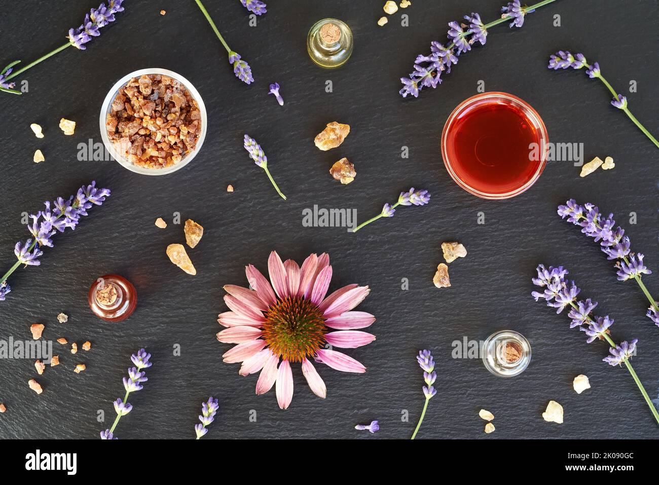 Dark background with bottles of aromatherapy essential oil with ...