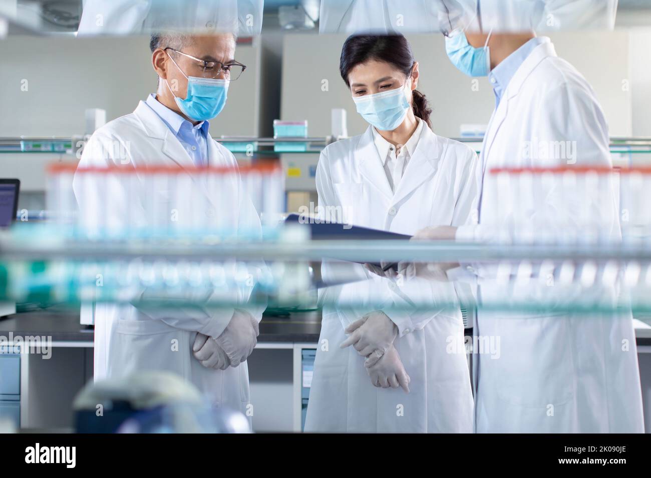 Three Chinese researchers discussing in laboratory Stock Photo - Alamy