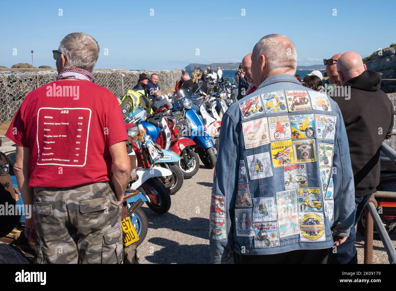 Scooter rally attendee wears a blue denim jacket covered with patches ...