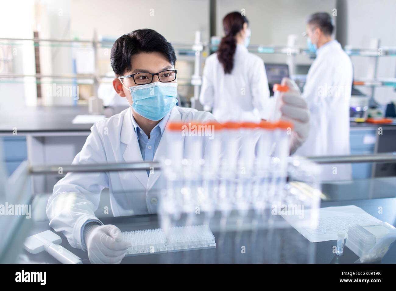 Chinese scientists examining medical sample in laboratory Stock Photo ...
