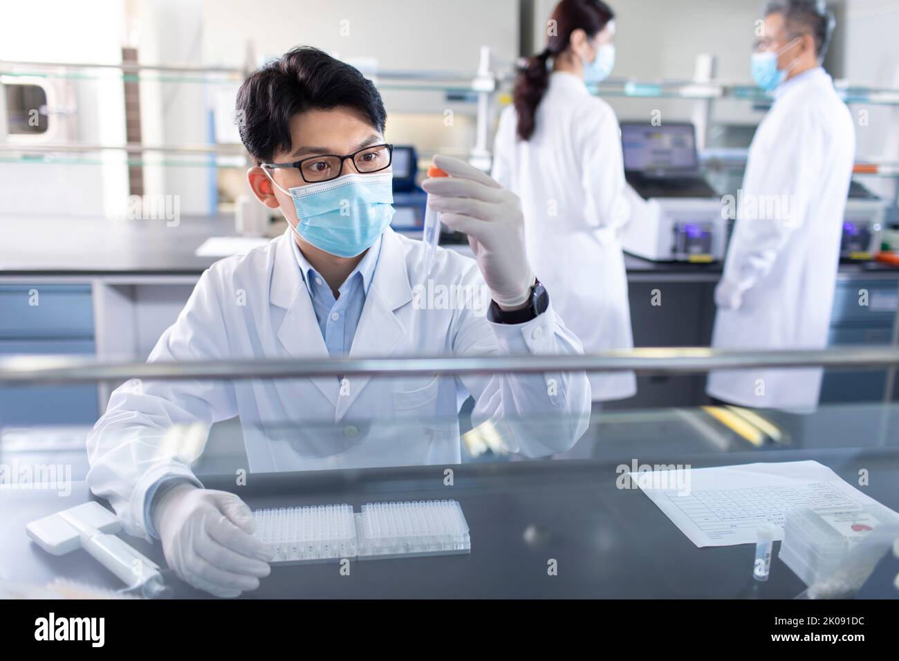 Chinese scientists examining medical sample in laboratory Stock Photo ...