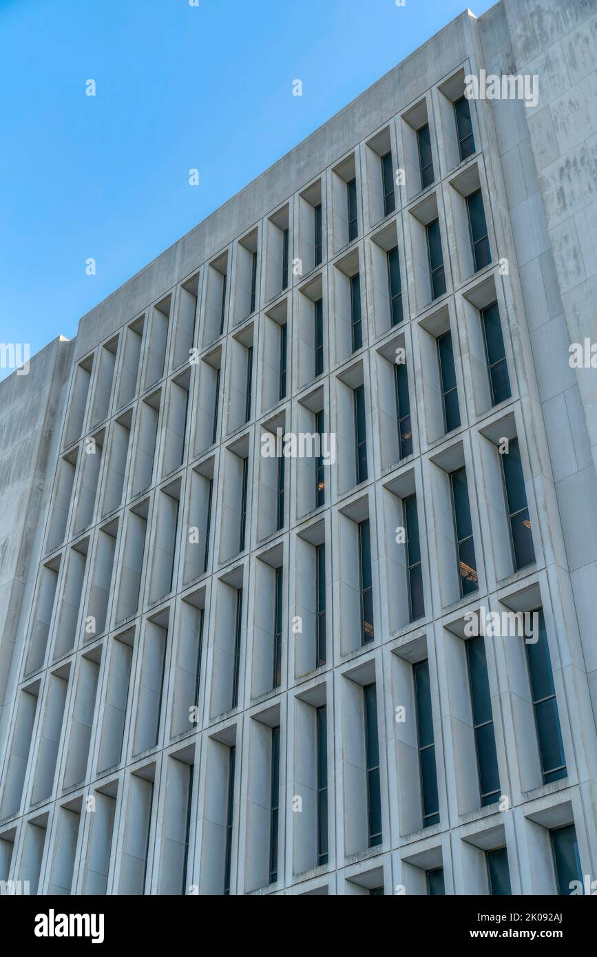 Exterior view of concrete modern building with blue sky background ...