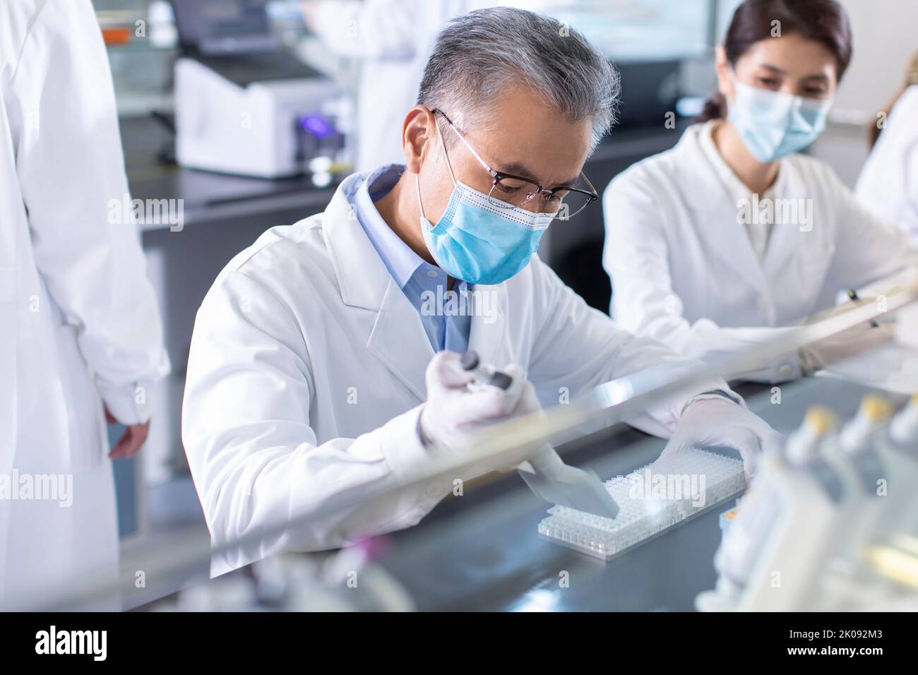 Chinese scientists examining medical sample in laboratory Stock Photo ...