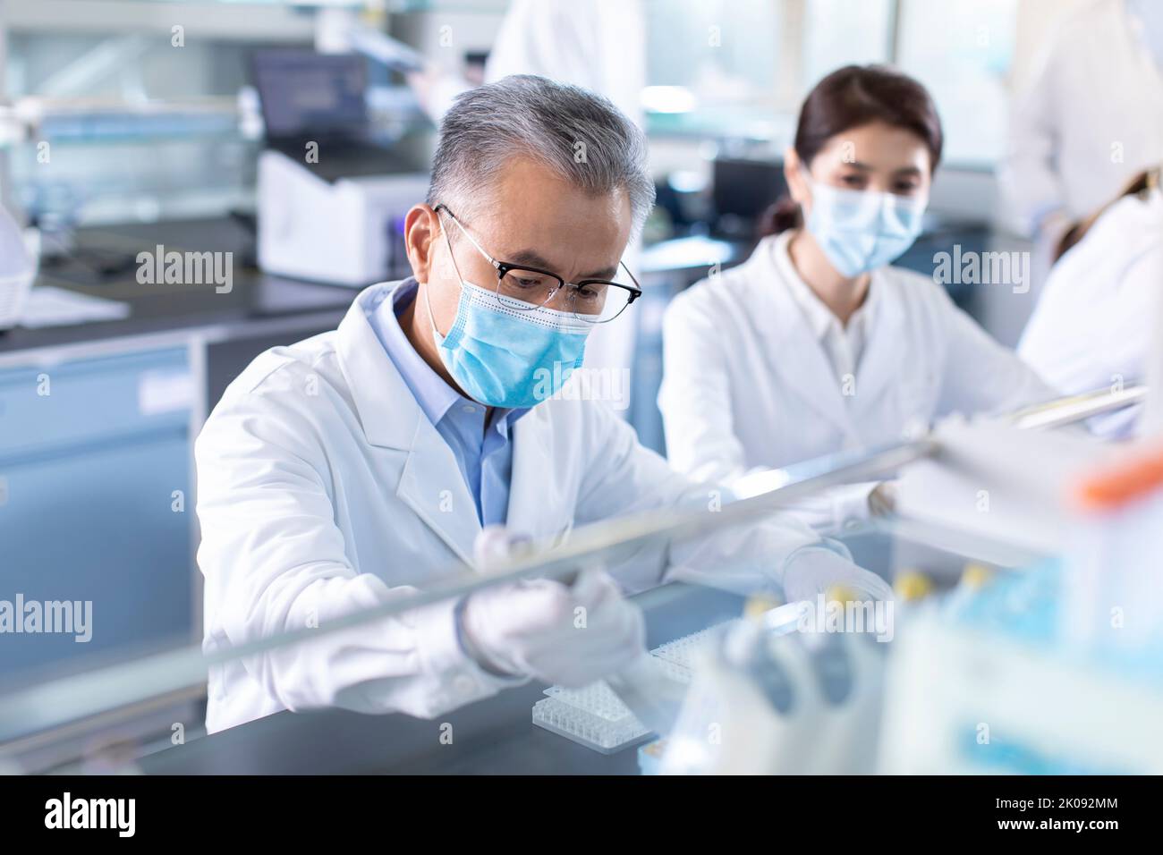 Chinese scientists examining medical sample in laboratory Stock Photo ...