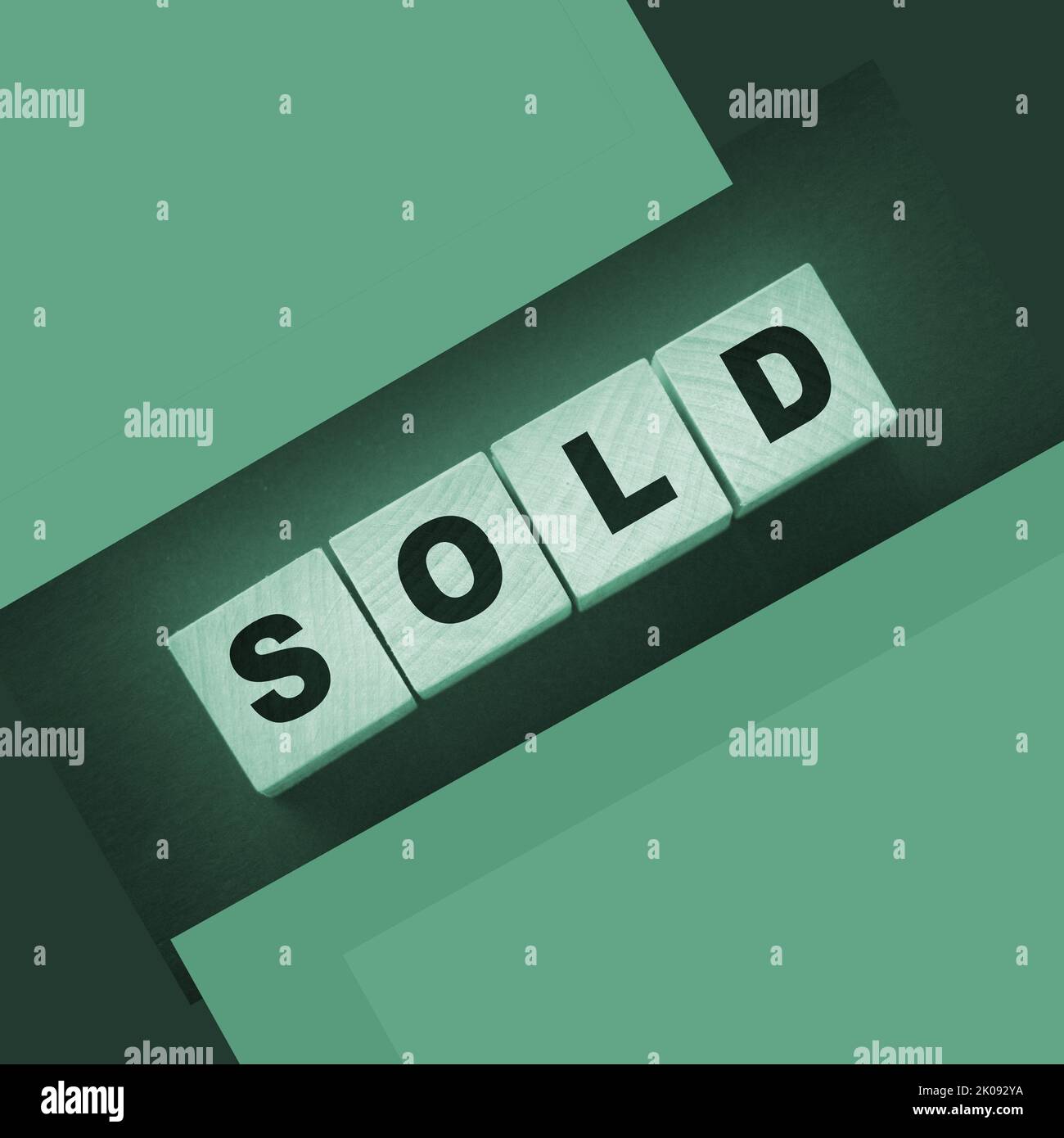 Sold Word Written In Wooden Cubes on black background. Real estate ...