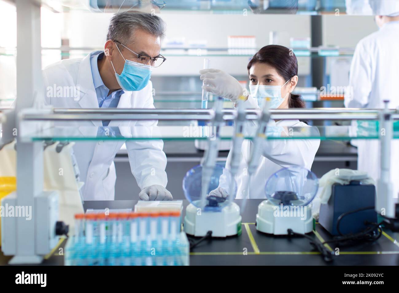 Chinese scientists examining medical sample in laboratory Stock Photo ...