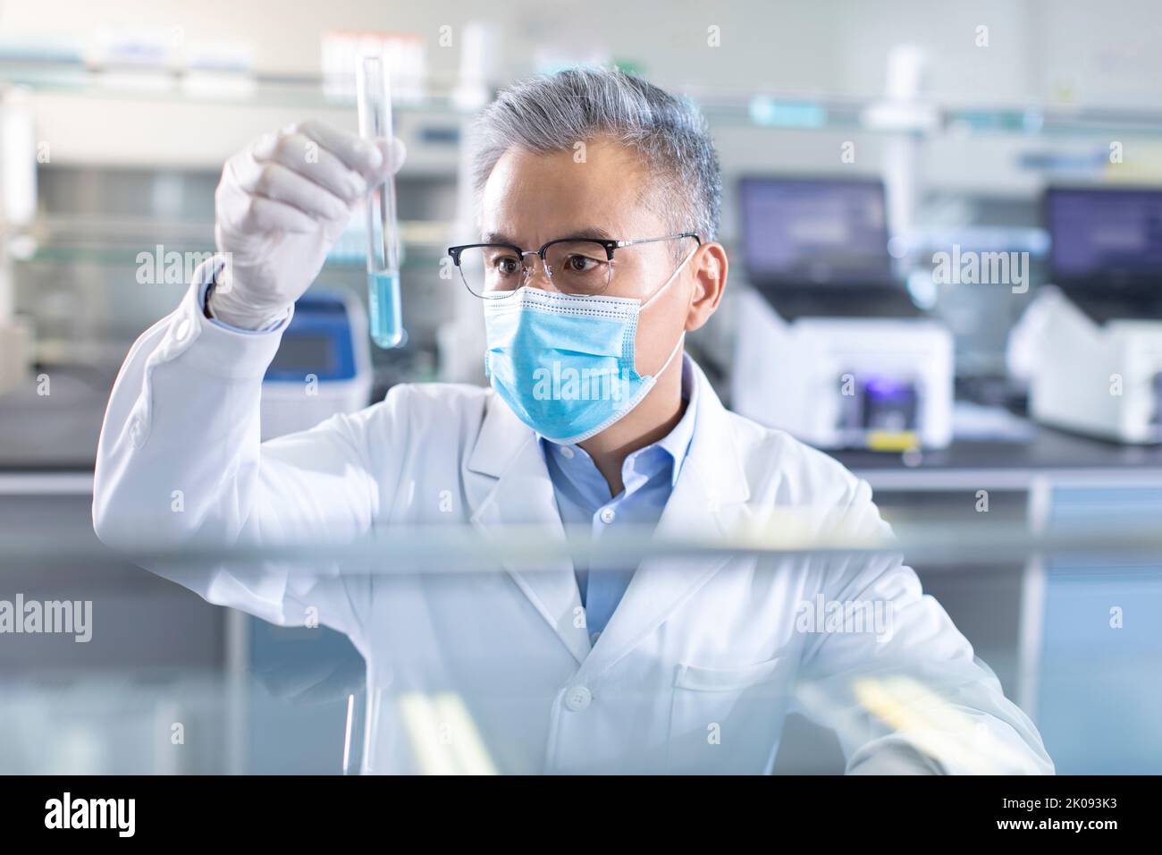 Chinese scientist examining medical sample in laboratory Stock Photo ...