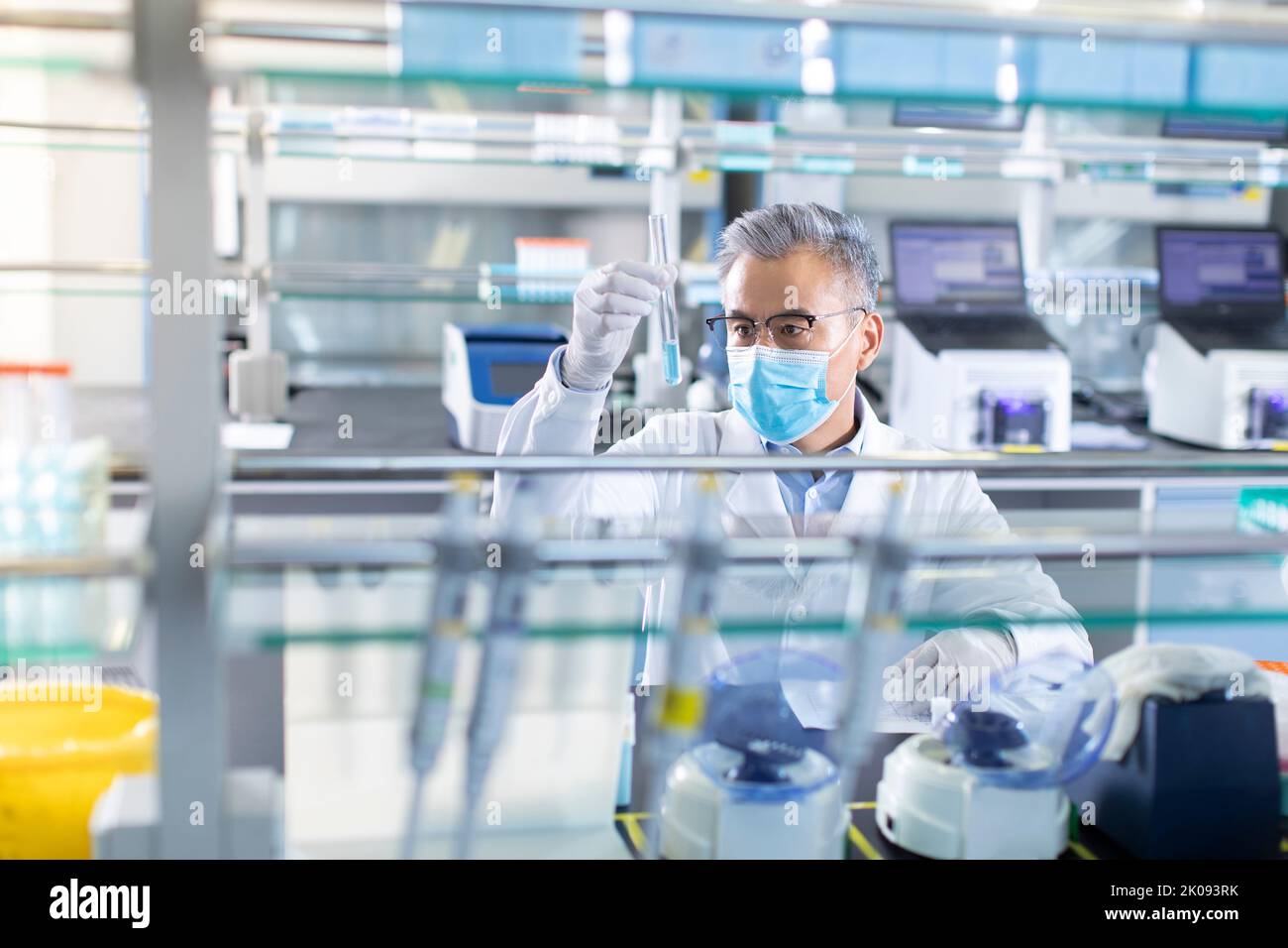 Chinese scientist examining medical sample in laboratory Stock Photo ...
