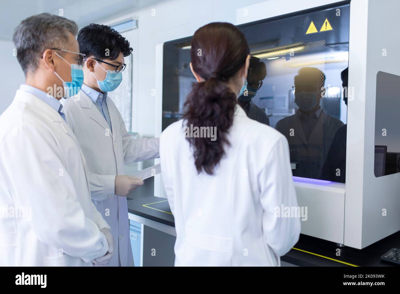 Three Chinese researchers working in laboratory Stock Photo - Alamy