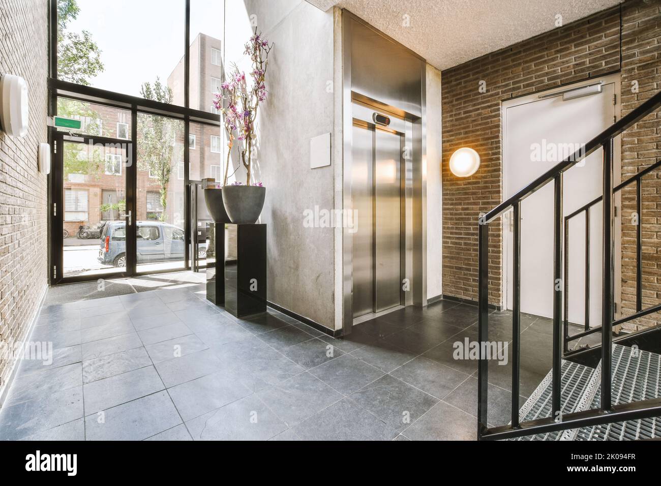 Shiny elevator with opened door located in illuminated hall of ...