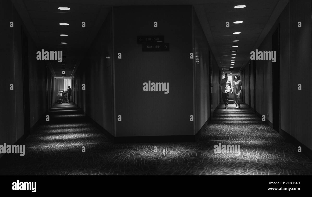 Couple in love standing and kissing in the corridor of the hotelwalking ...