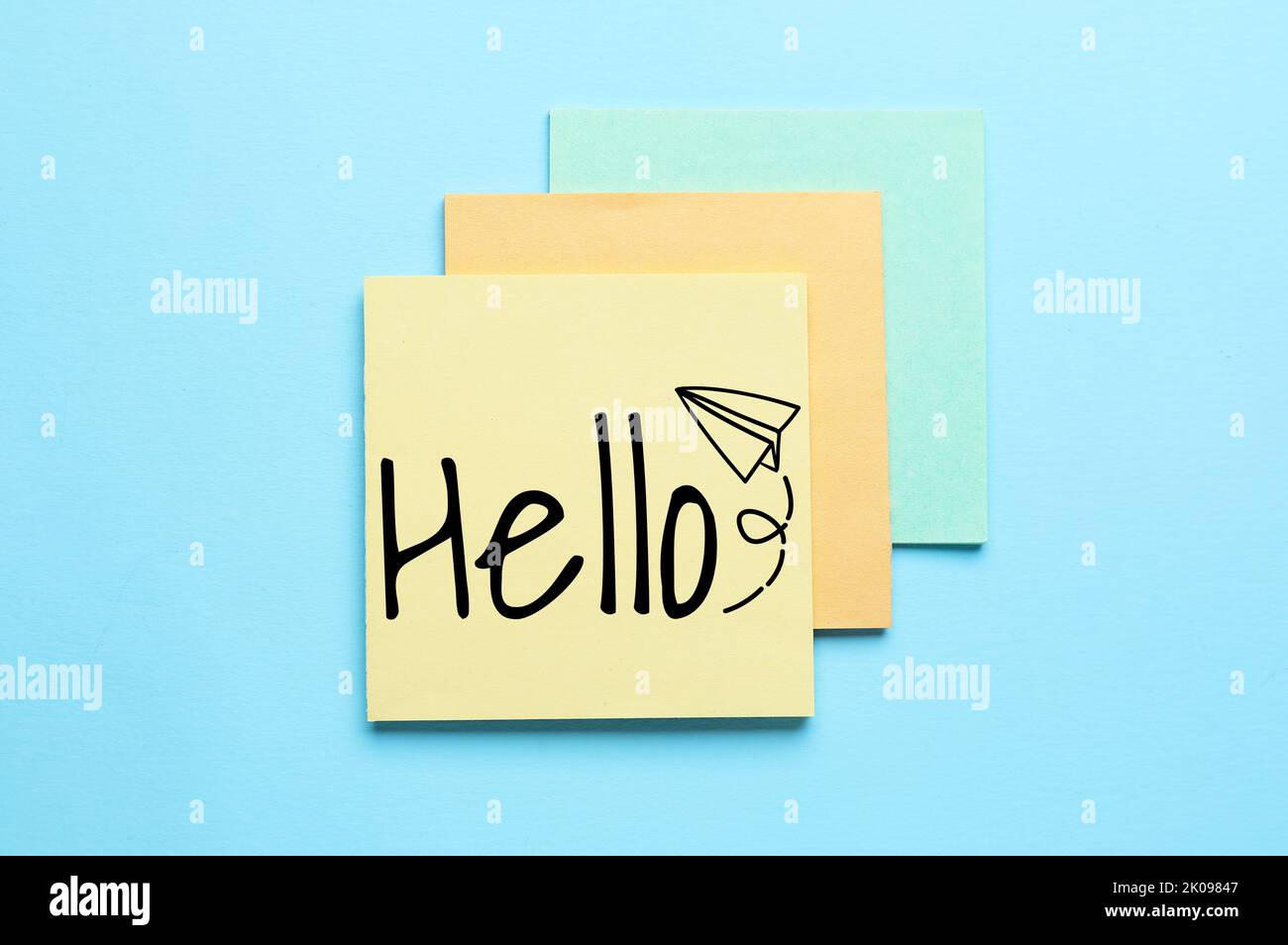 Sticky notes with word HELLO on light blue background Stock Photo - Alamy