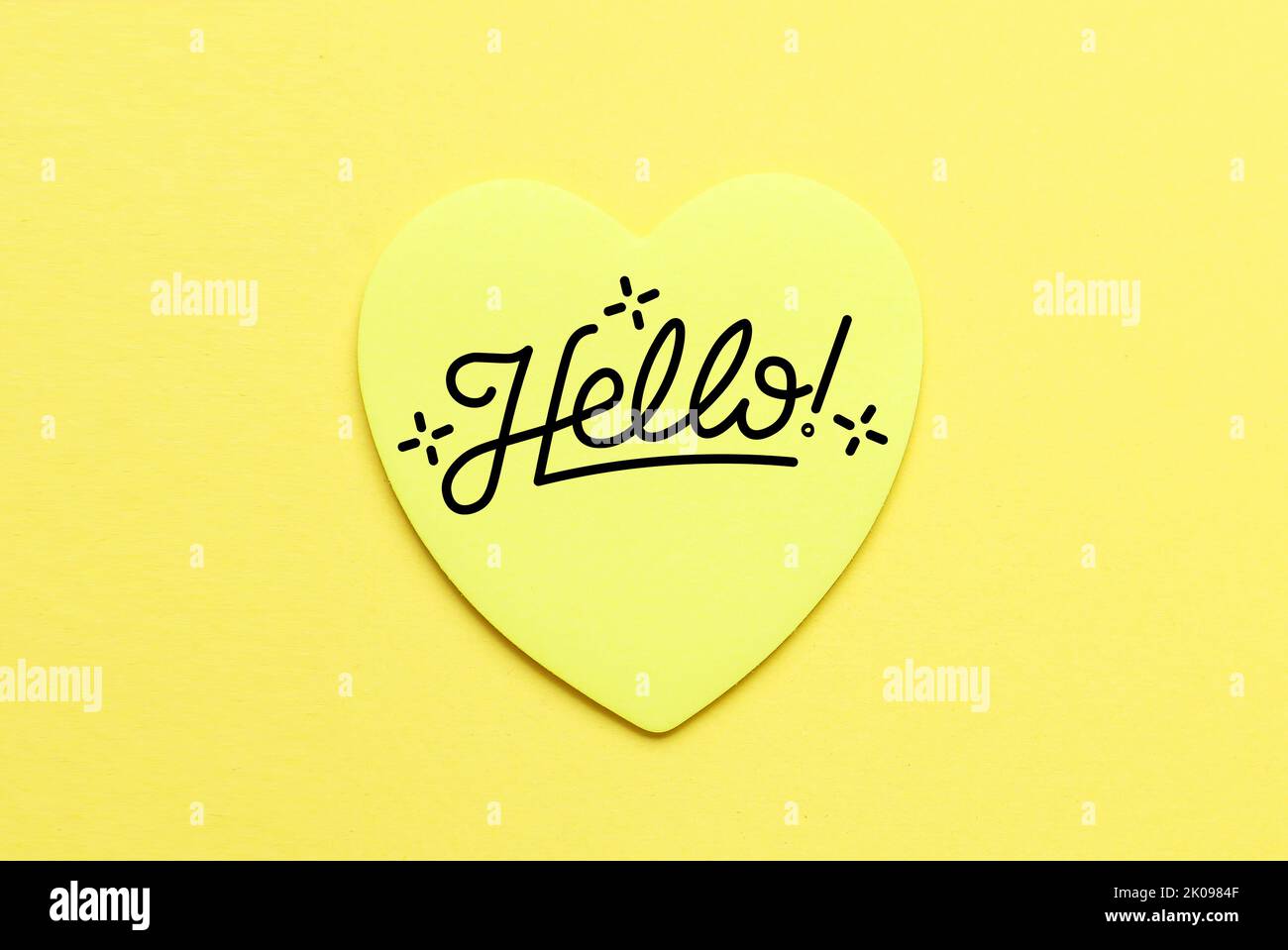 Heart-shaped sticky note with word HELLO on yellow background Stock ...