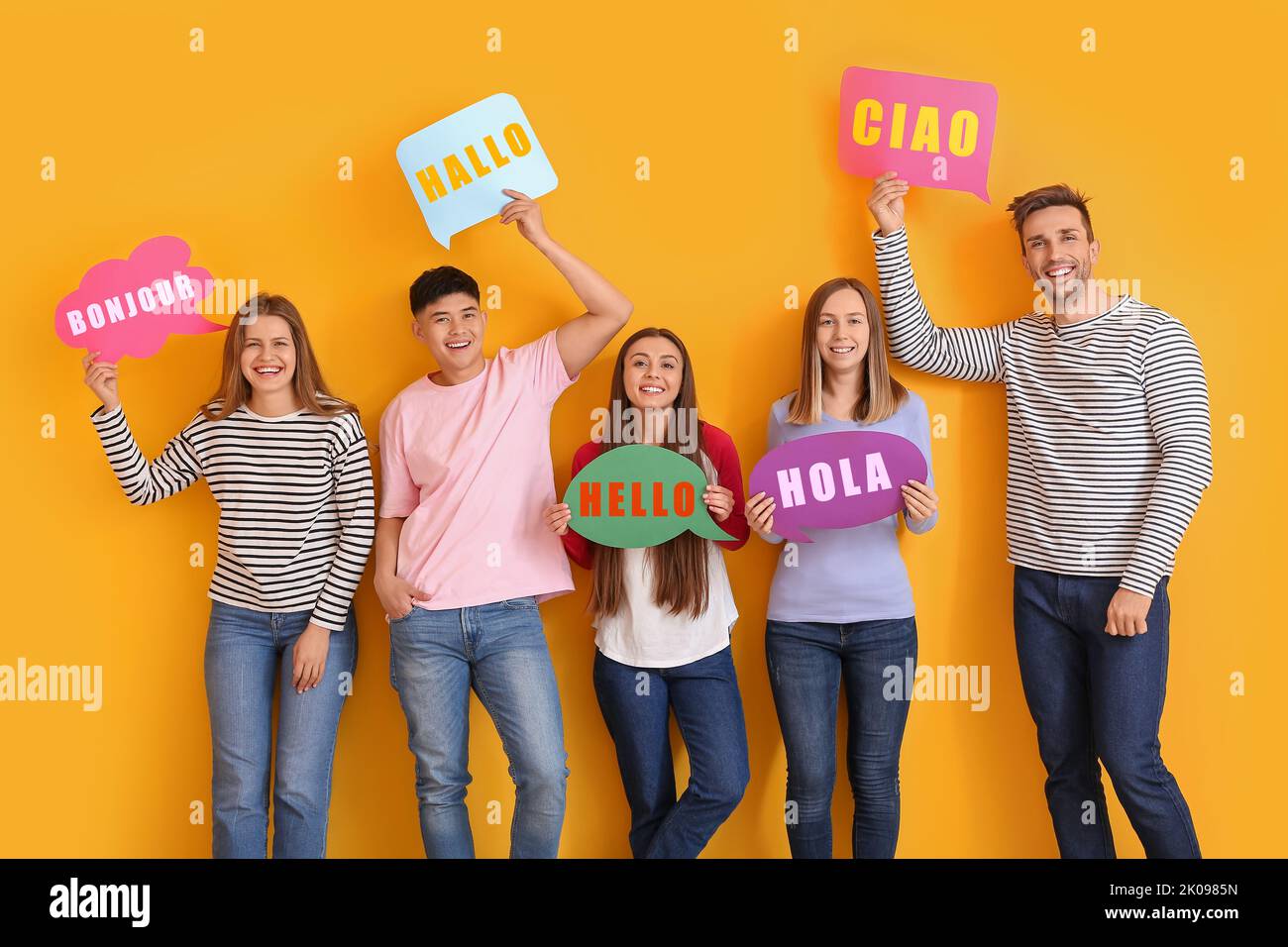 Group of young people holding speech bubbles with words HELLO in ...