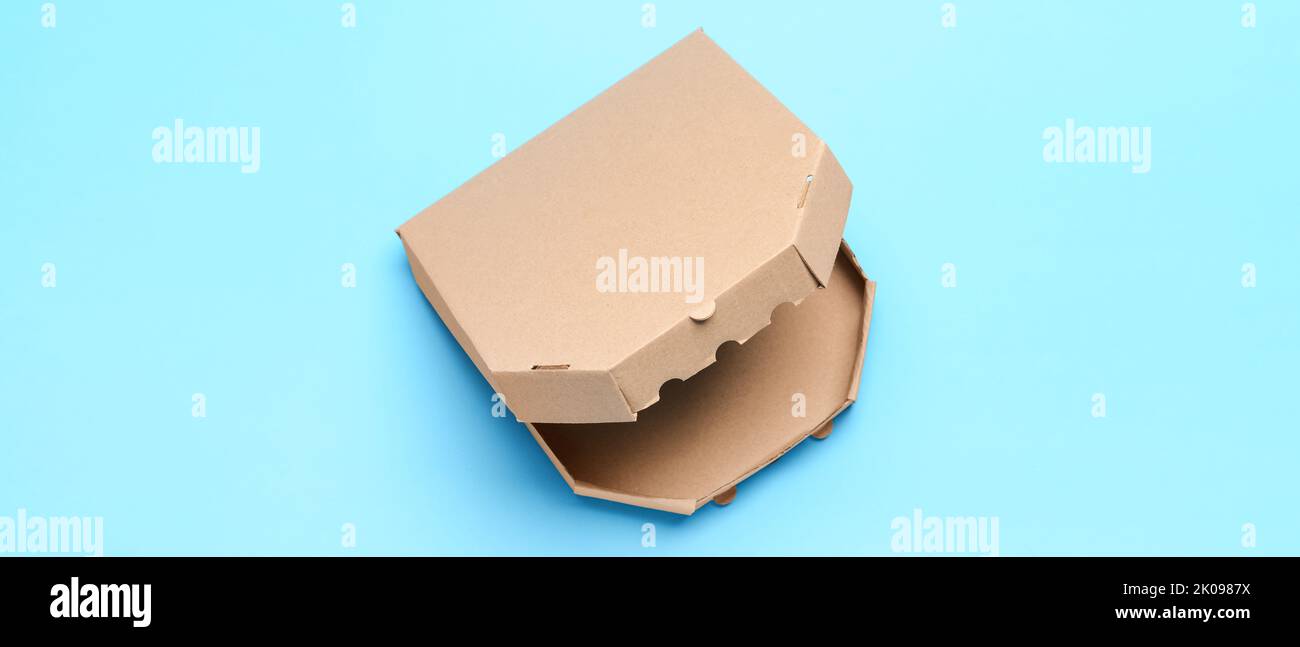 Cardboard pizza box on light blue background Stock Photo - Alamy