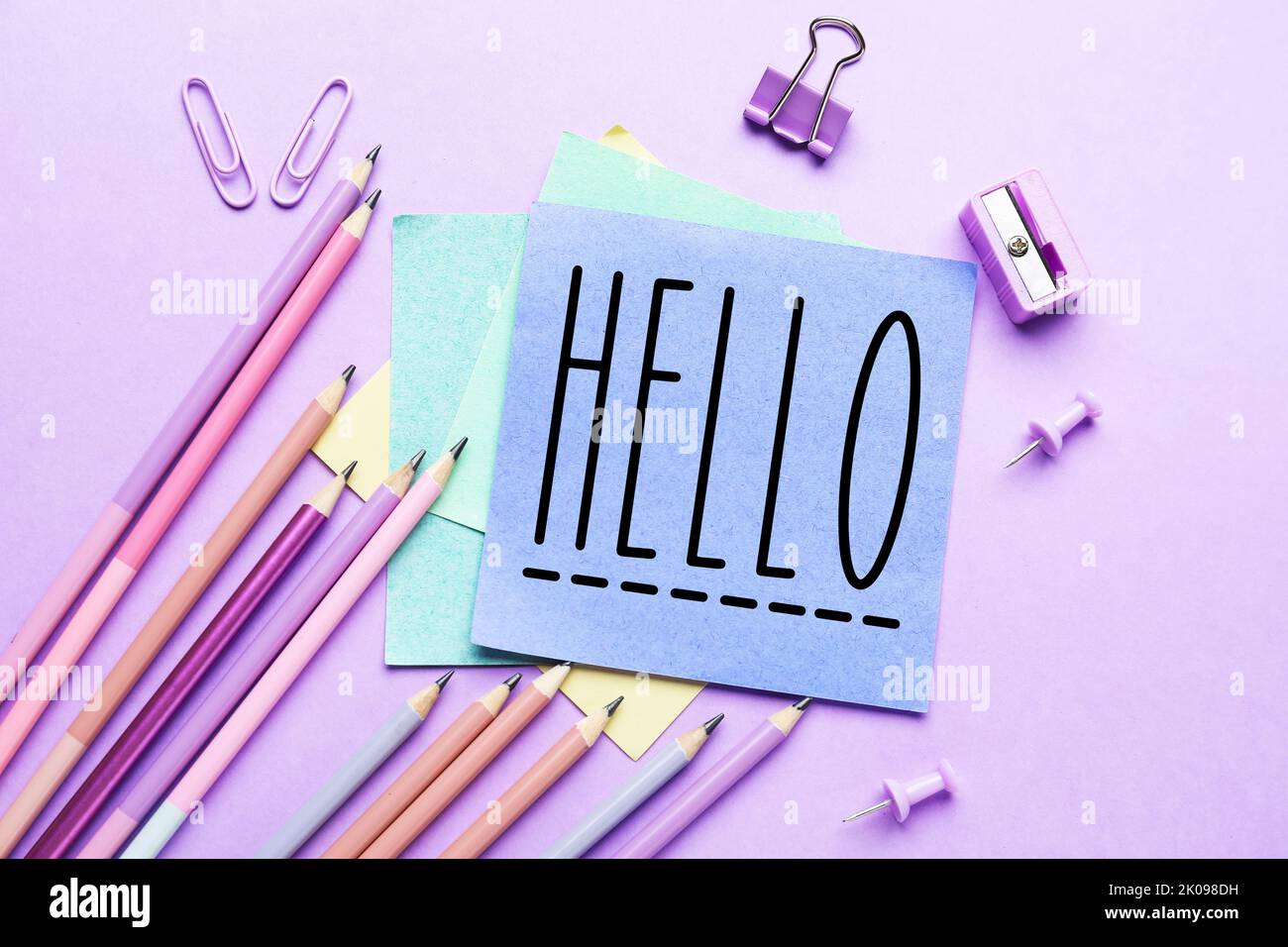 Sticky note with word HELLO and stationery on lilac background Stock ...