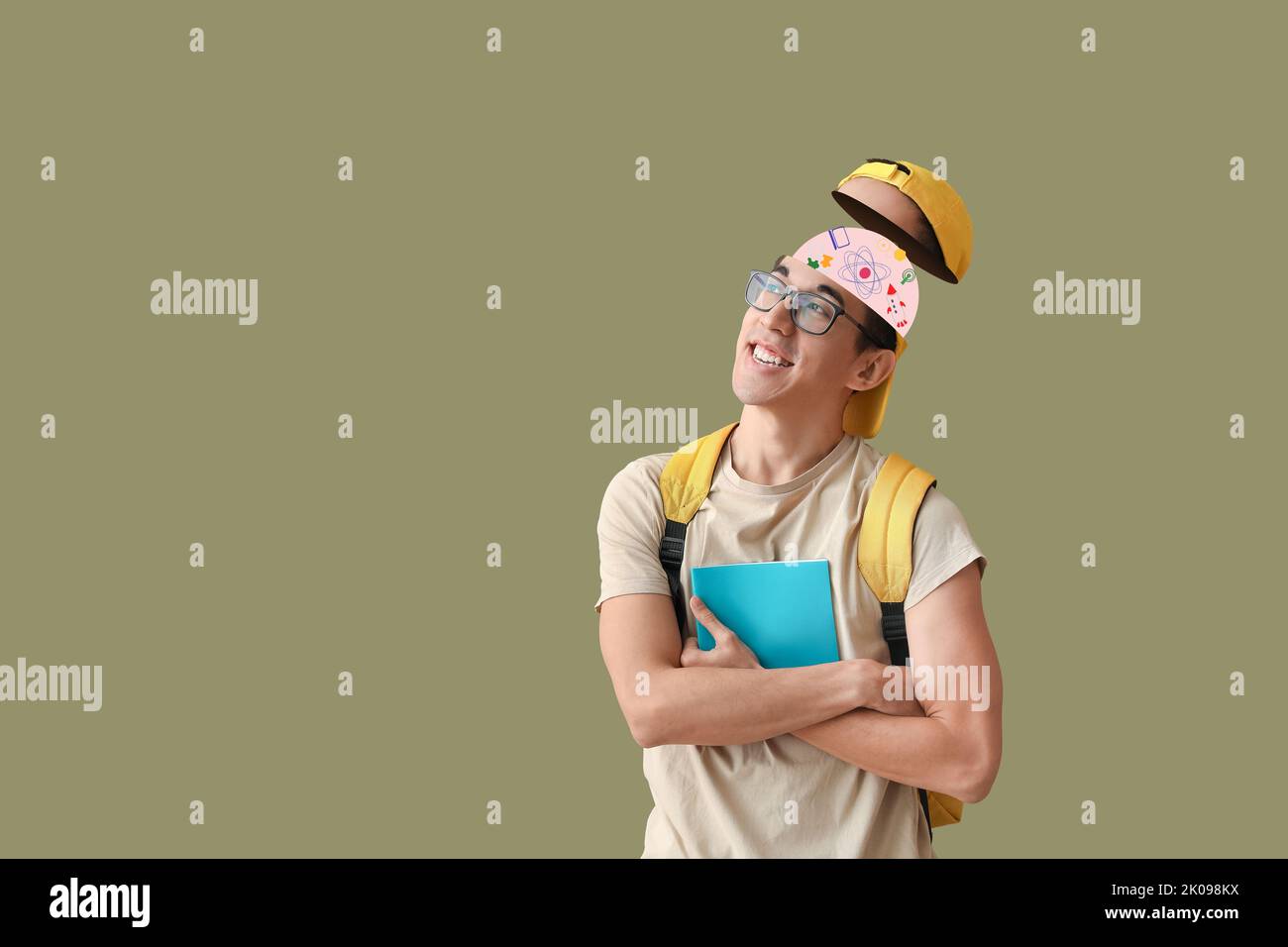 Smart Asian student with copybook on green background Stock Photo - Alamy