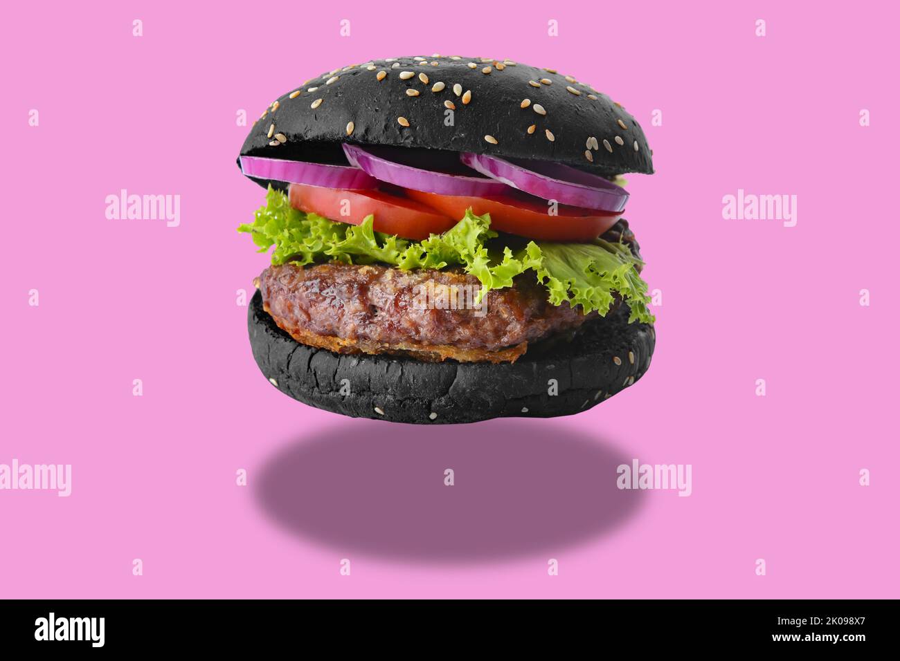 Tasty fresh burger with black bun on pink background Stock Photo - Alamy